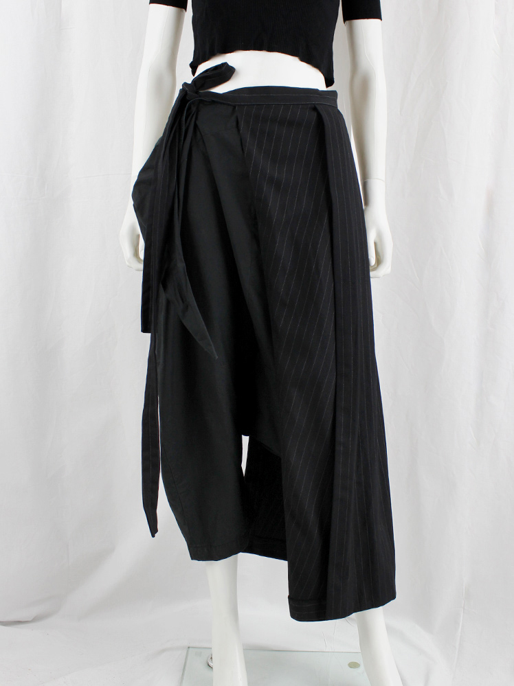 Comme des Garçons black pinstripe pleated half-skirt worn as Comme des Garçons black pinstripe pleated half-skirt worn as