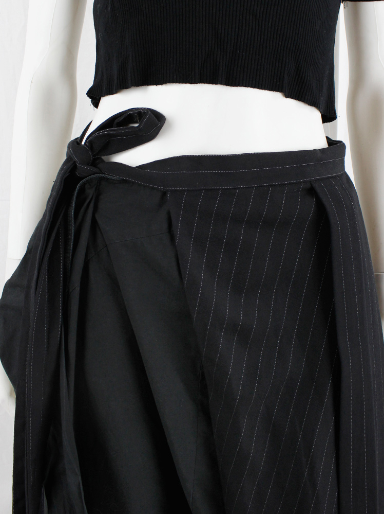 Comme des Garçons black pinstripe pleated half-skirt worn as Comme des Garçons black pinstripe pleated half-skirt worn as